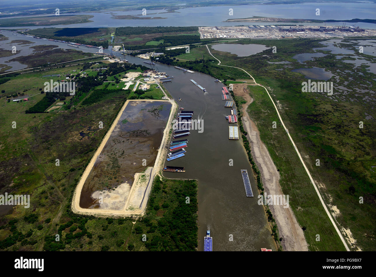 Tugs maneuver barges along the Gulf Intracoastal Waterway on Aug. 18 ...