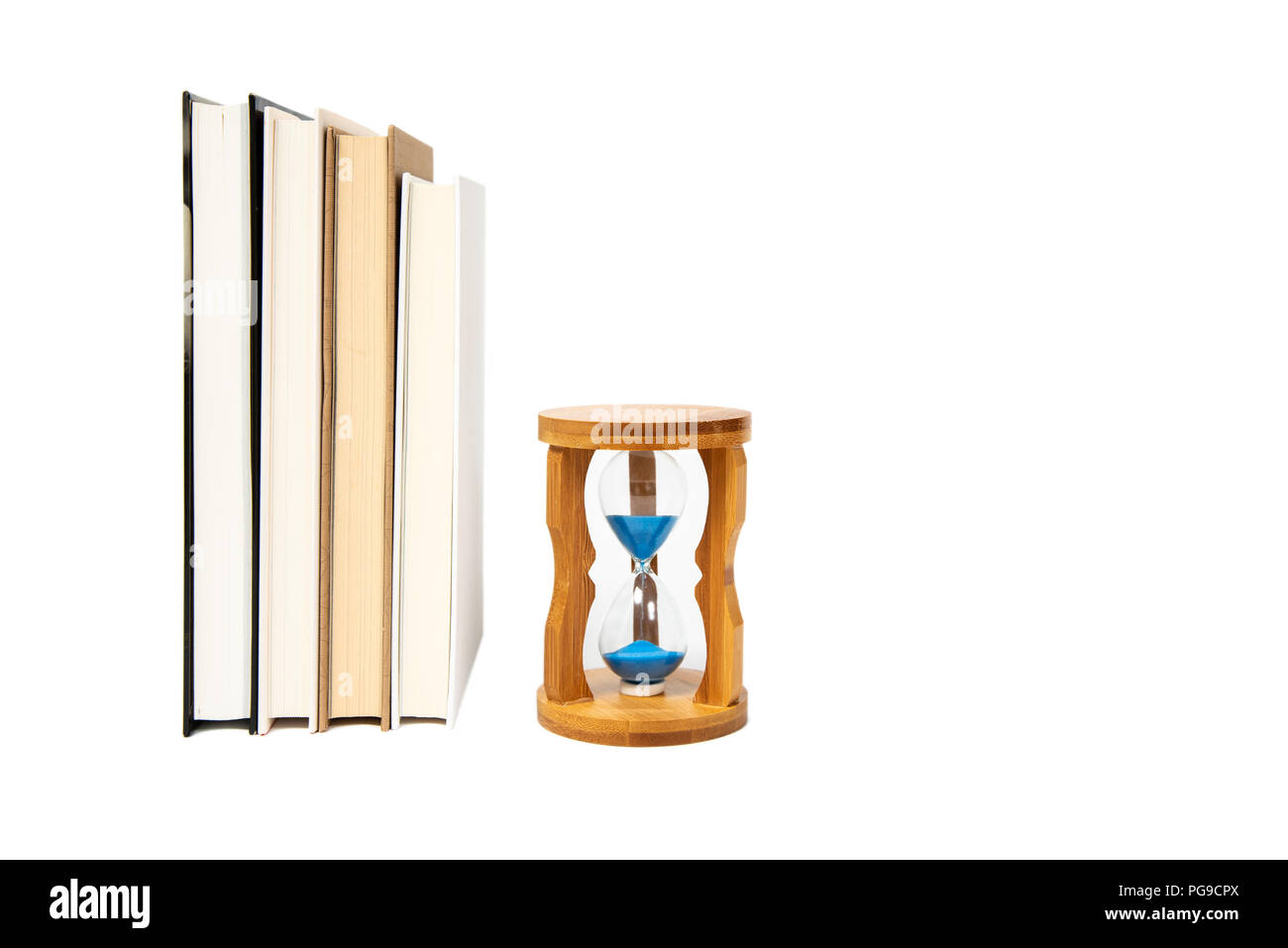Hourglass and books isolated on white background Stock Photo - Alamy