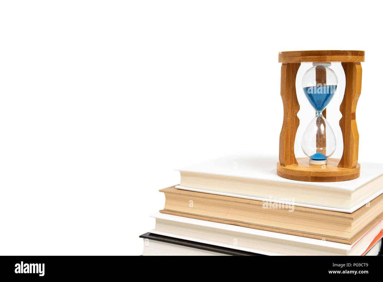 Hourglass and books isolated on white background Stock Photo - Alamy