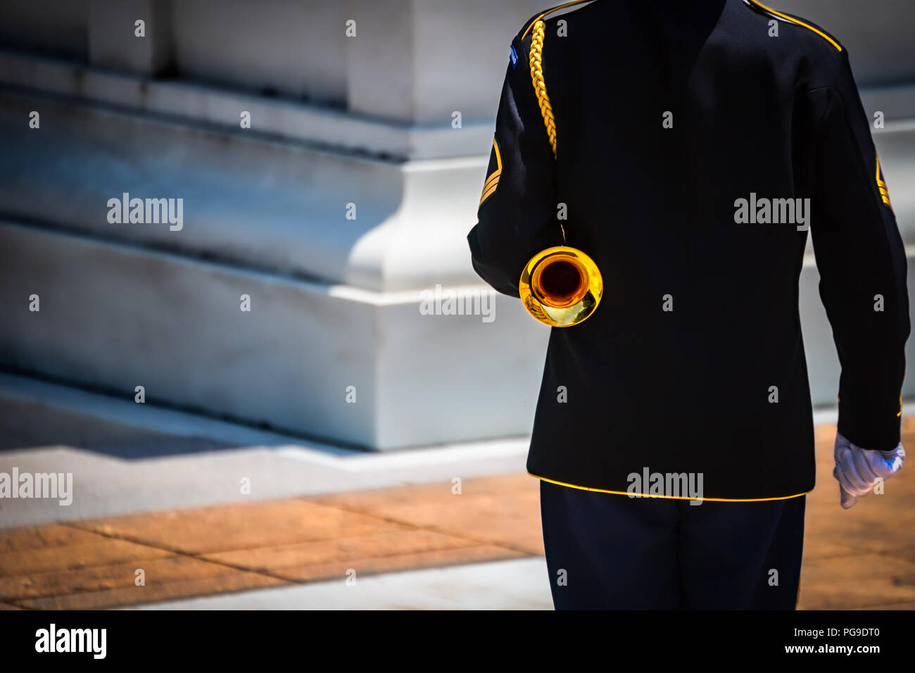 A US Army bugler stands at attention and ready to sound taps at a ...