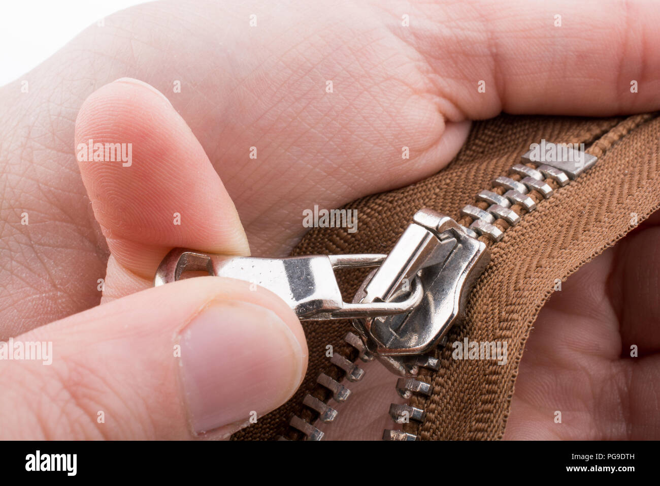 Hand holding color zipper on a white background Stock Photo - Alamy