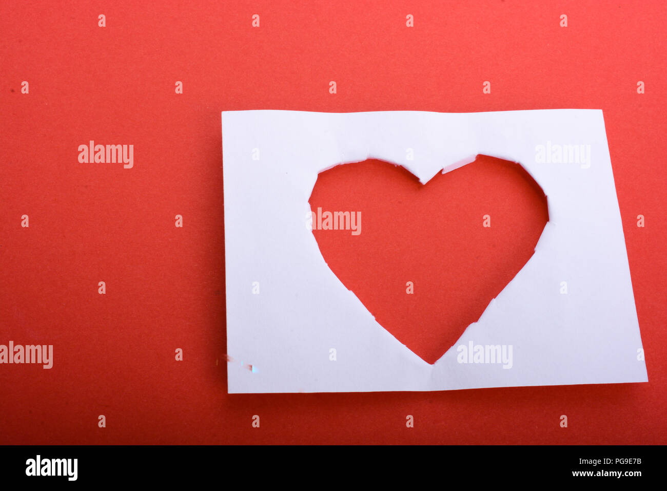 Heart shape cut out of paper on a white background Stock Photo - Alamy