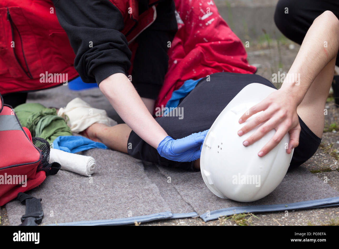 First aid training with simulation of workplace accident and helping ...