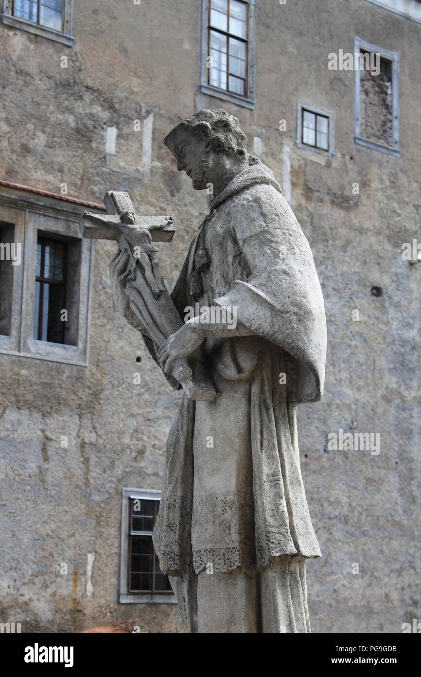 Statue of a saint with cross in his arms in Cesky Krumlov, Czech ...