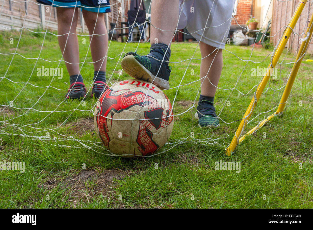 Kids playing football in garden hi-res stock photography and images - Alamy