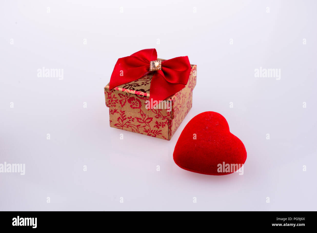 Gift box near red shape hi-res stock photography and images - Alamy