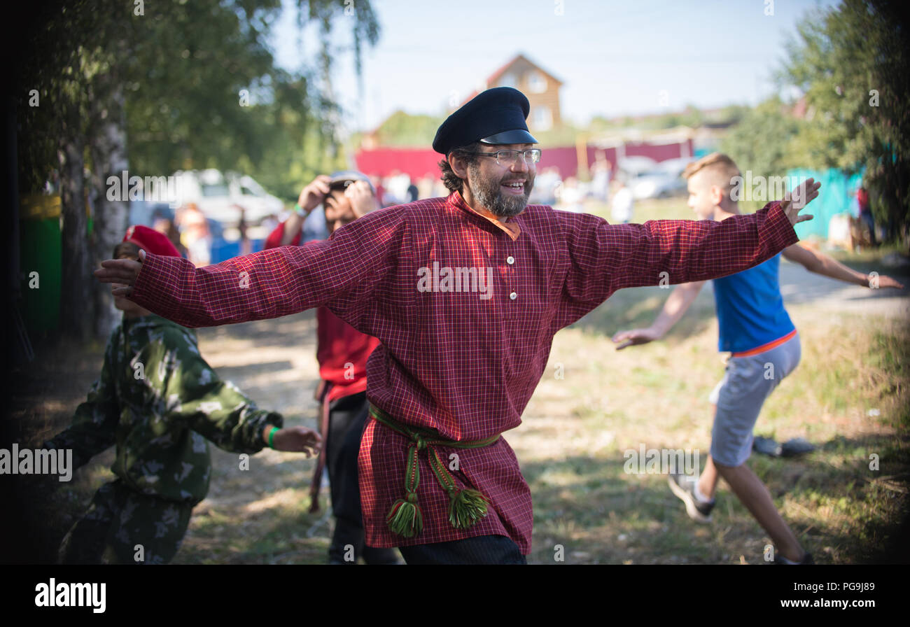 A man in a Russian-folk costume from the heart dancing on a Slavic ...