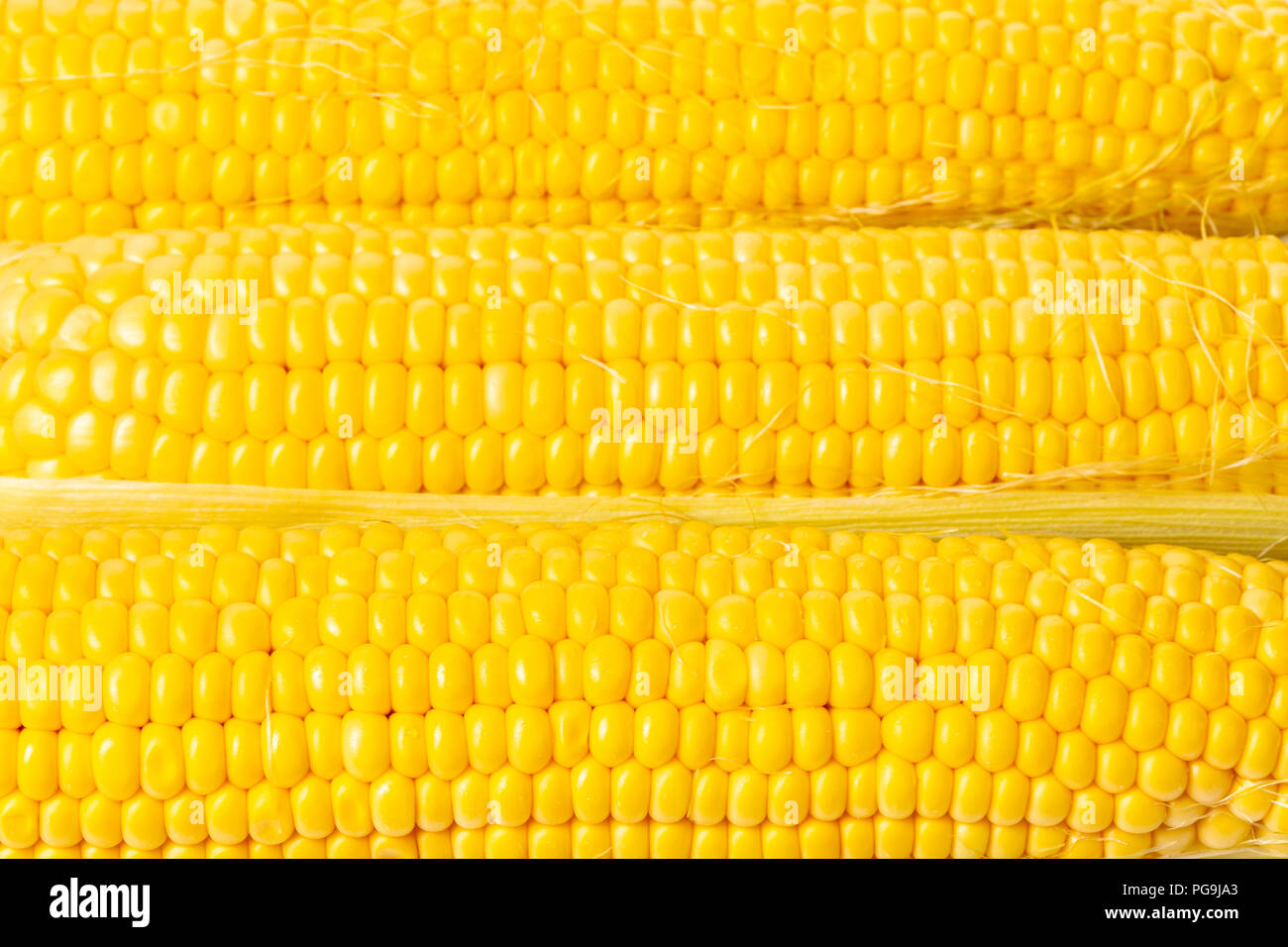 food background of a texture of corn cobs closeup Stock Photo - Alamy