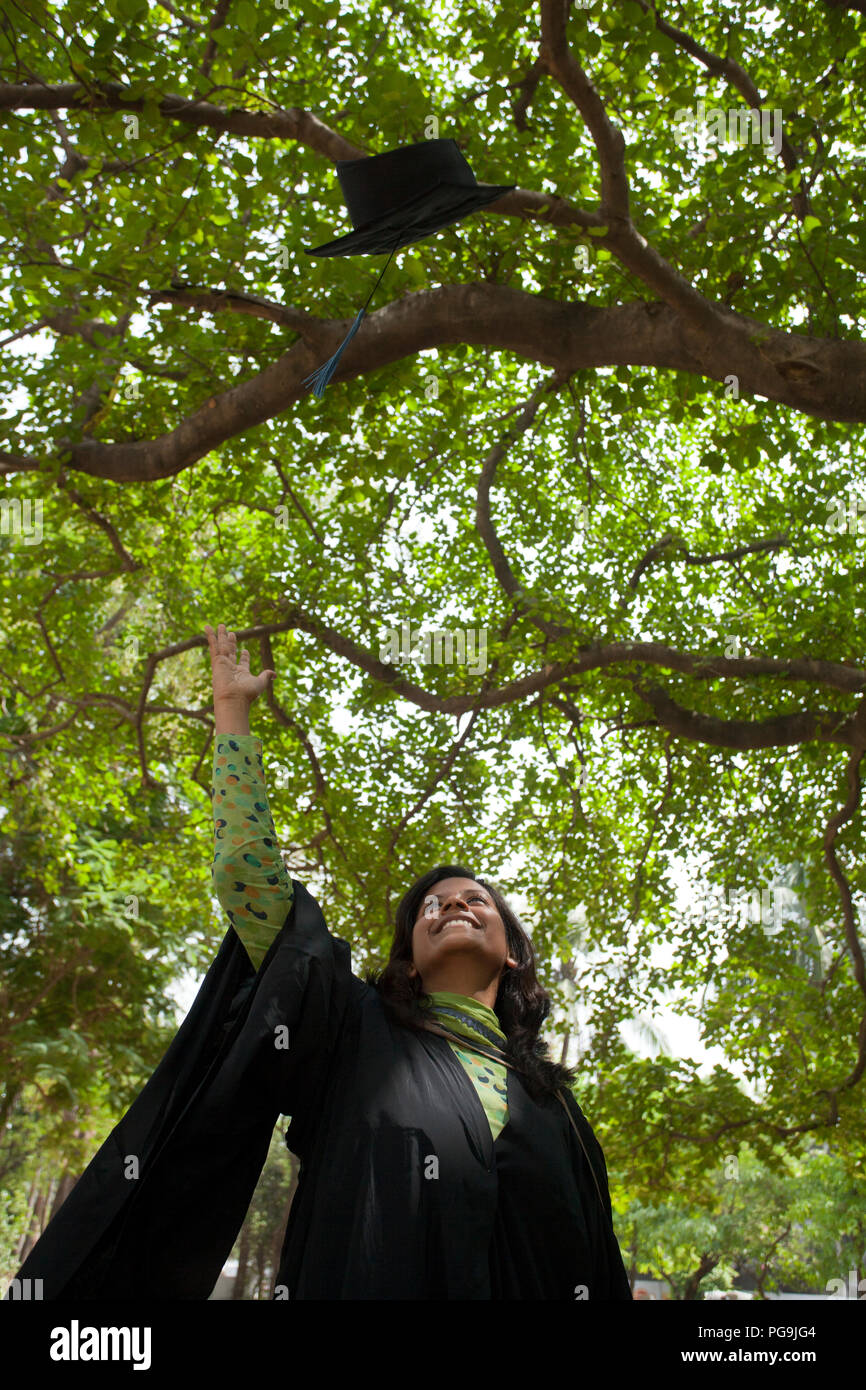 A graduate throws her hat during the 46th Convocation of the students ...