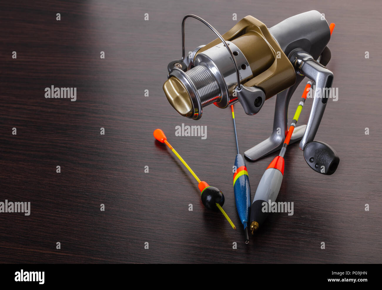 Coil and floats for a fishing rod on a wooden background Stock Photo ...
