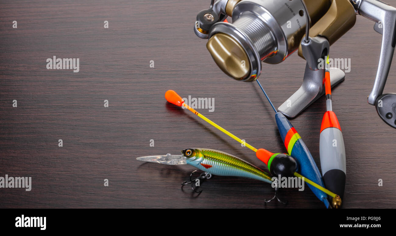 Coil and floats for a fishing rod on a wooden background Stock Photo ...