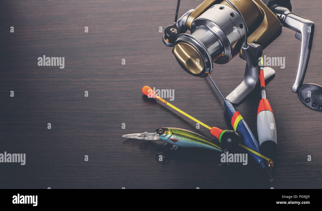 Coil and floats for a fishing rod on a wooden background Stock Photo ...