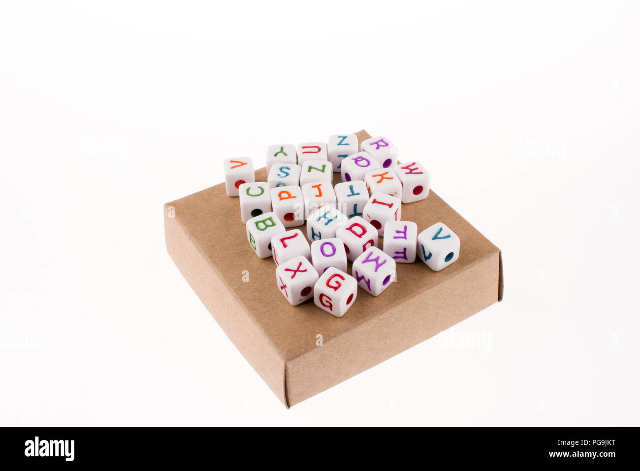 letter cubes placed on a box on a white background Stock Photo - Alamy