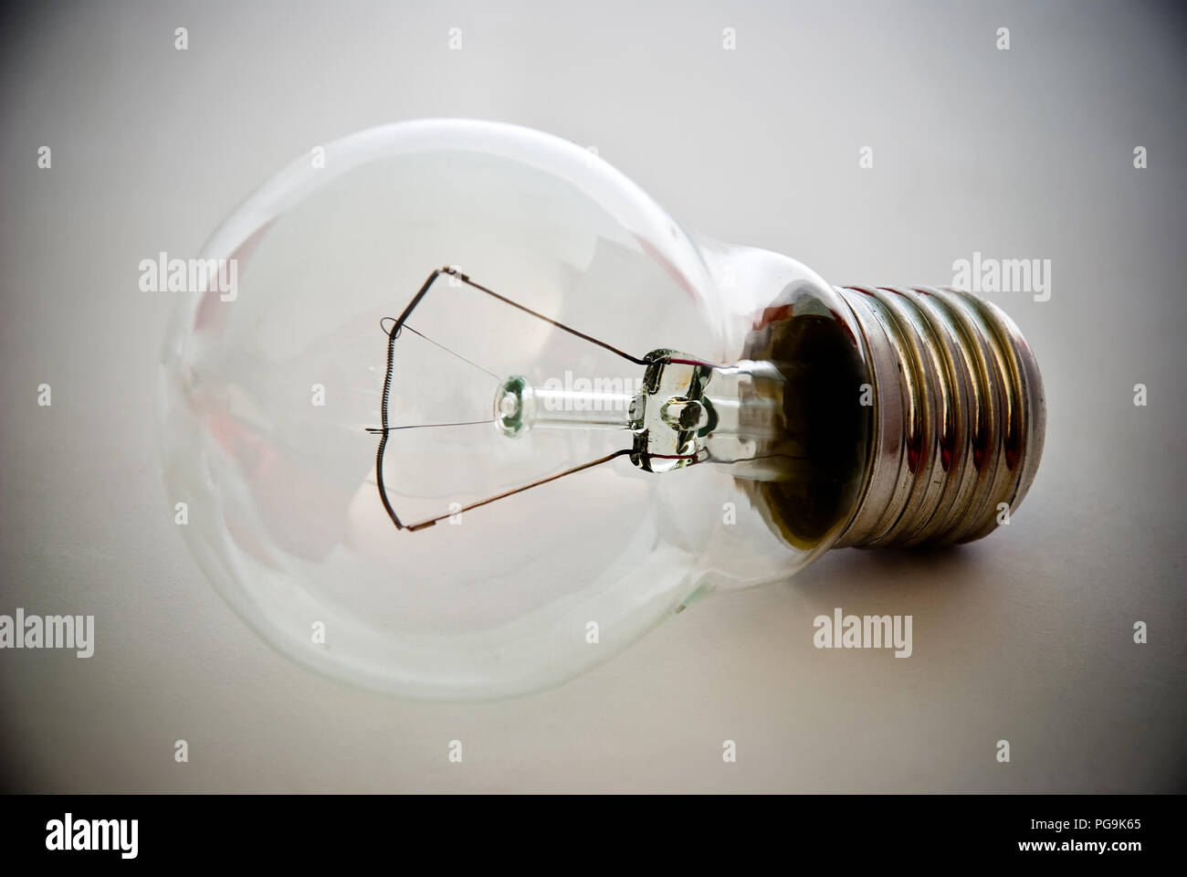 single bulb on a grey background Stock Photo - Alamy