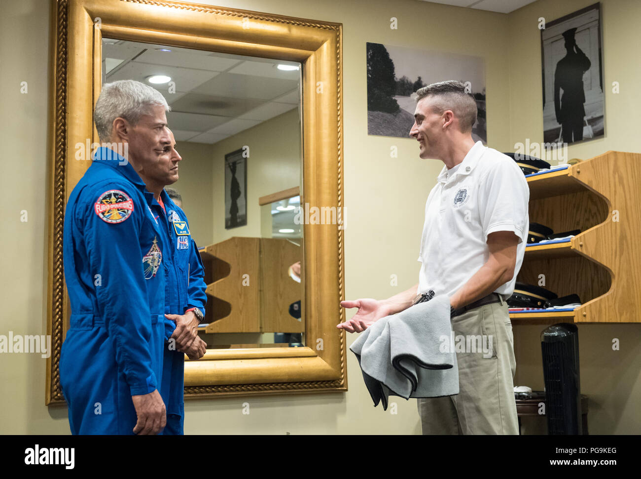 NASA astronauts Mark Vande Hei, left, and Joe Acaba, center, listen as ...