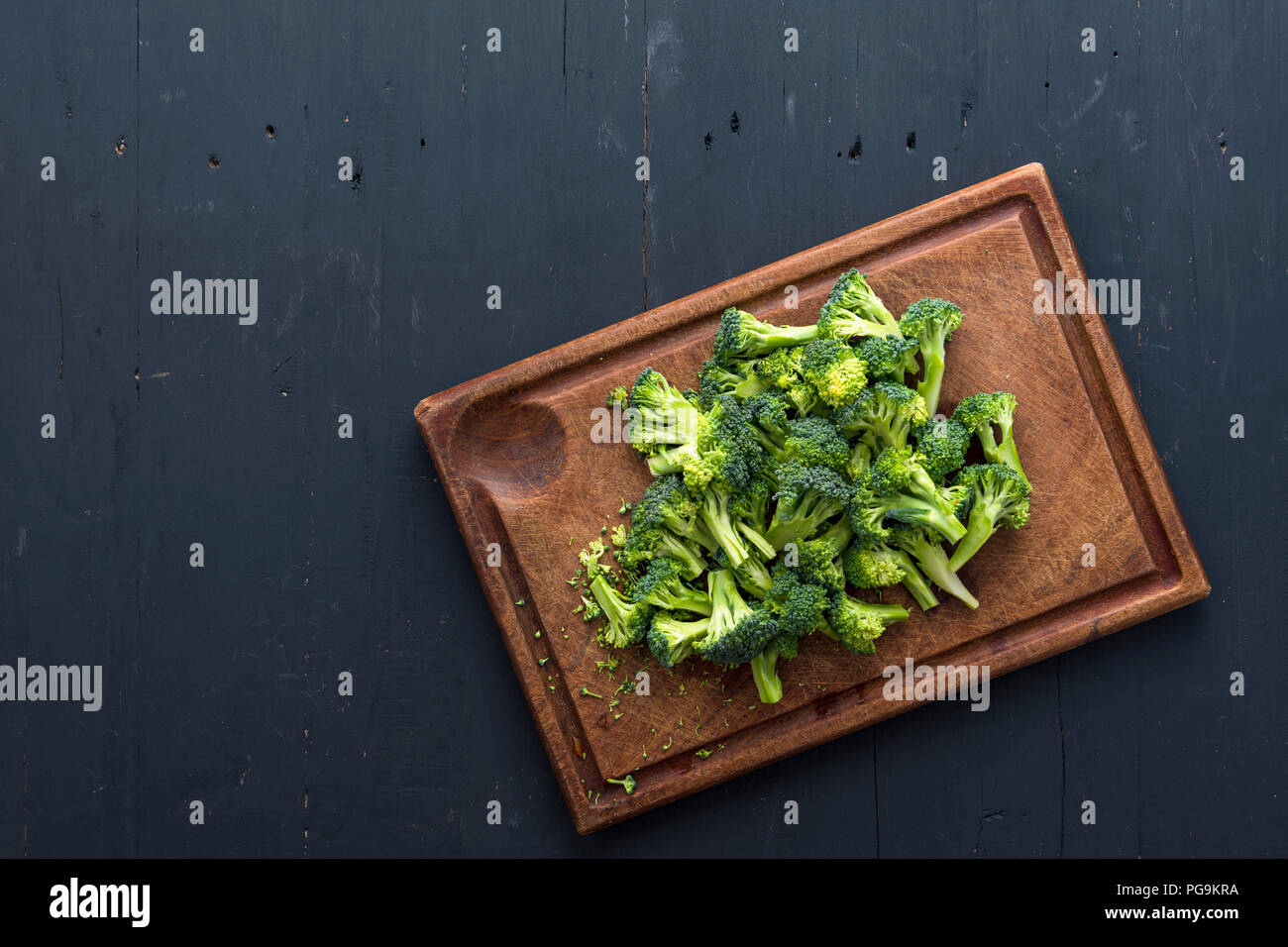 A pile of Broccoli vegetables seen on a wooden chopping board Stock ...