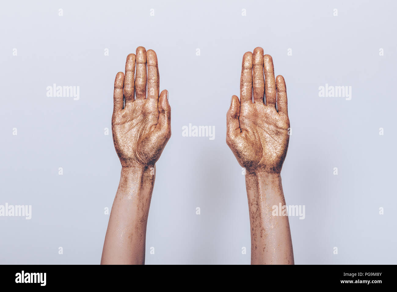 Woman's both hands painted golden sequins showing two palms on white ...