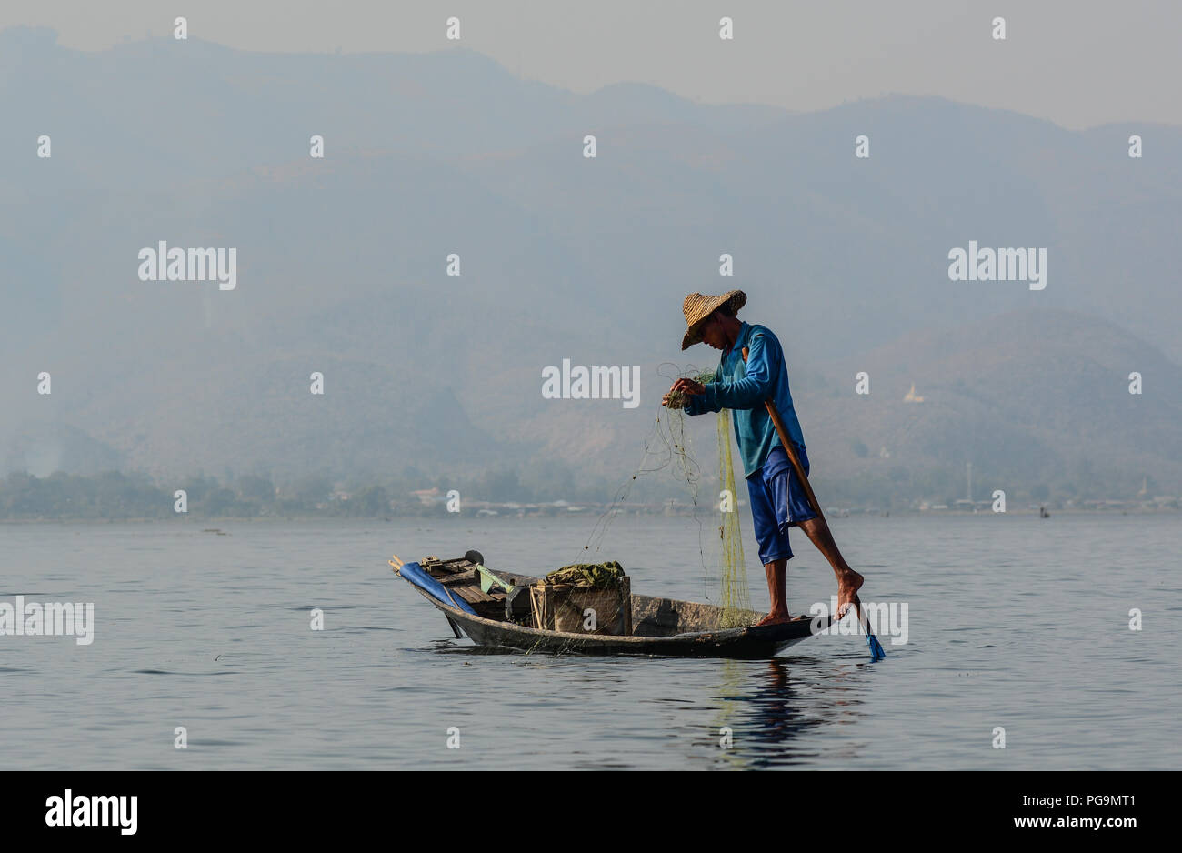 Inle, Myanmar - Feb 14, 2016. Burmese man using the unique methods of ...