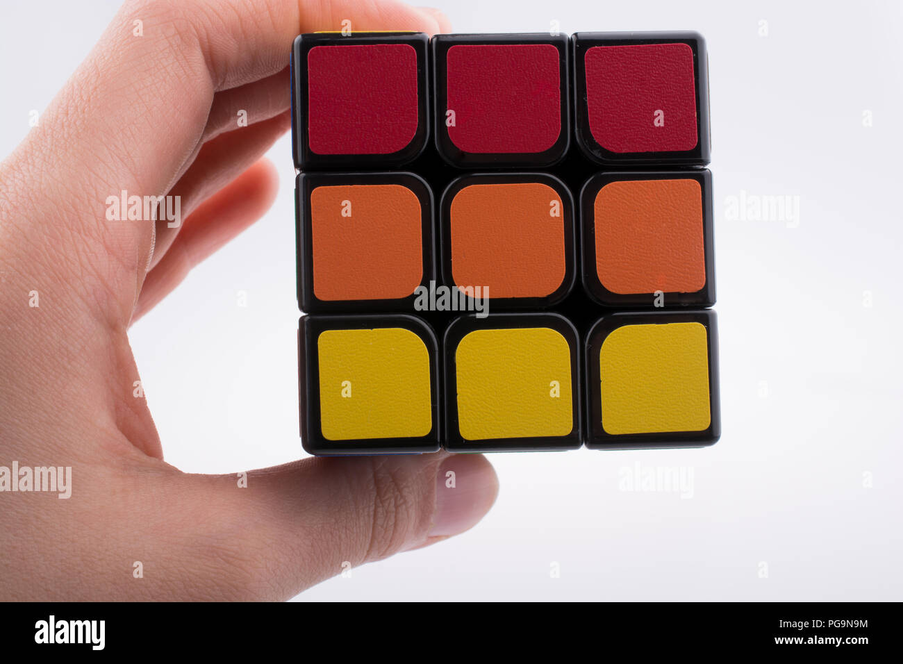 hand holding Rubik's cube on white background Stock Photo - Alamy