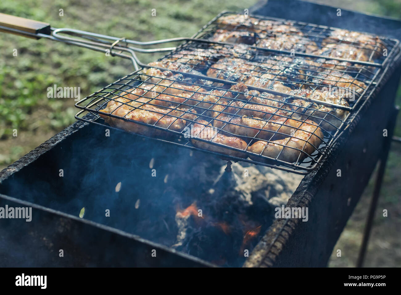 fried sausages on grill with coals and tongues of flame Stock Photo - Alamy