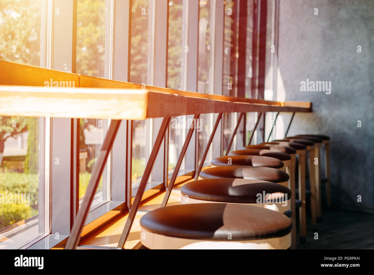 interior cafe. Bar chairs stand in row near large window Stock Photo ...
