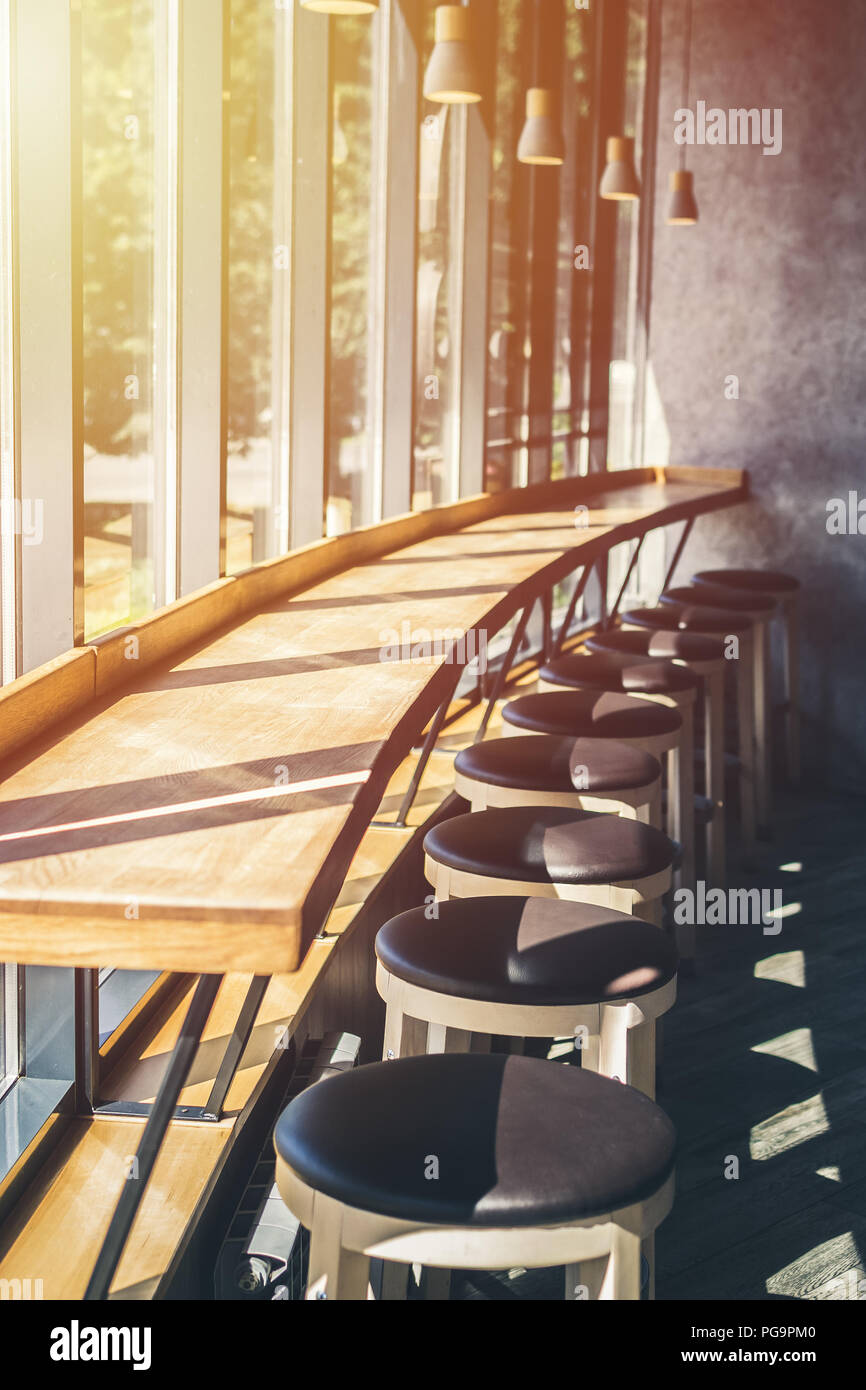 interior cafe. Bar chairs stand in row near large window Stock Photo ...