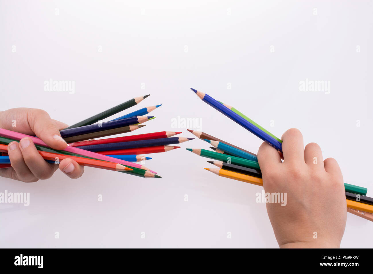Hand holding color pencils on a white background Stock Photo - Alamy