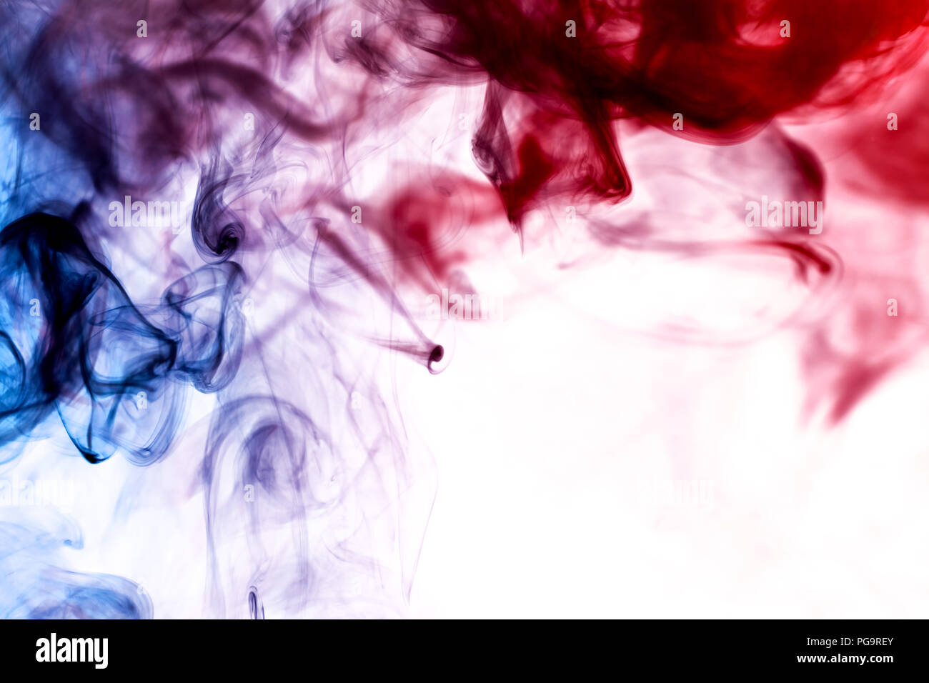 Thick red,blue smoke on a white isolated background. Background from ...