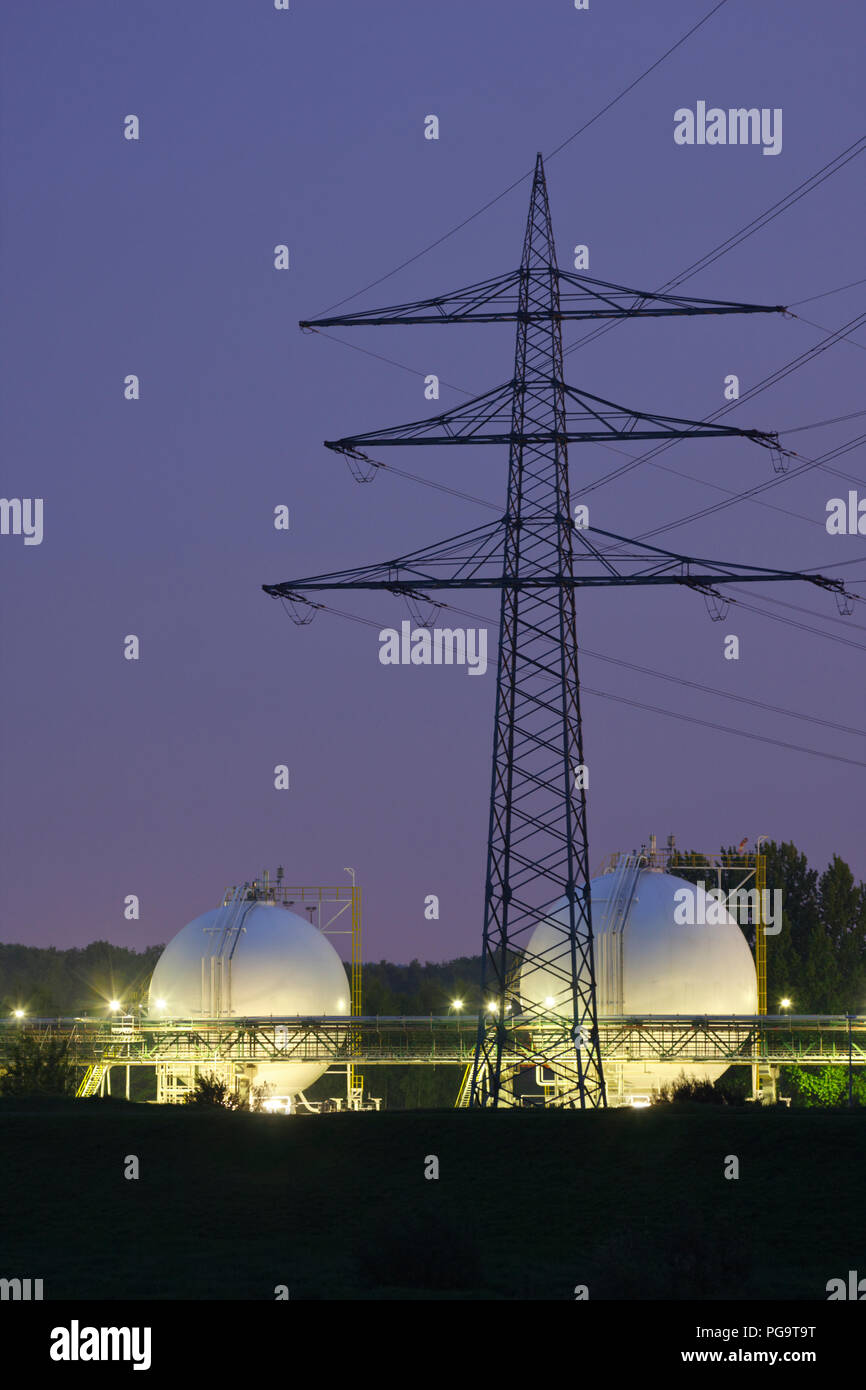 Night shot of two liquid gas tanks behind an electricity pylon Stock ...