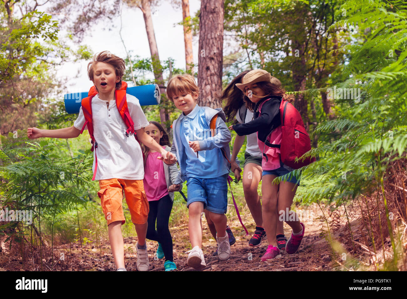 Kids running together forest hi-res stock photography and images - Alamy