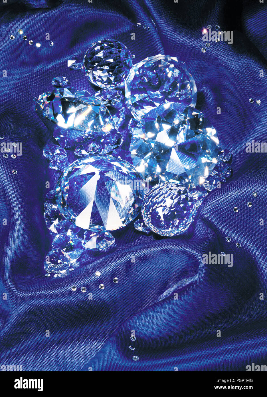 Jewelery shining on blue cloth Stock Photo - Alamy