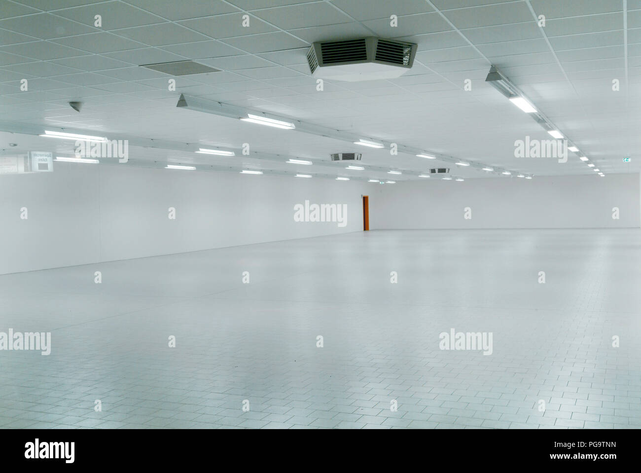 A white empty hall with an red door Stock Photo - Alamy