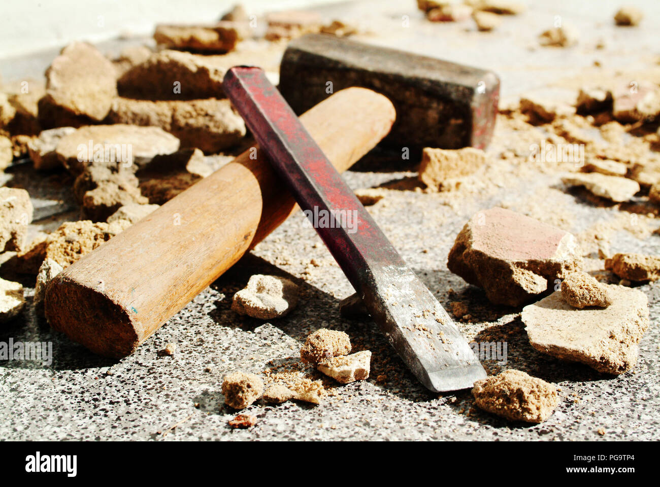 Hammer and chisel between boulders Stock Photo - Alamy