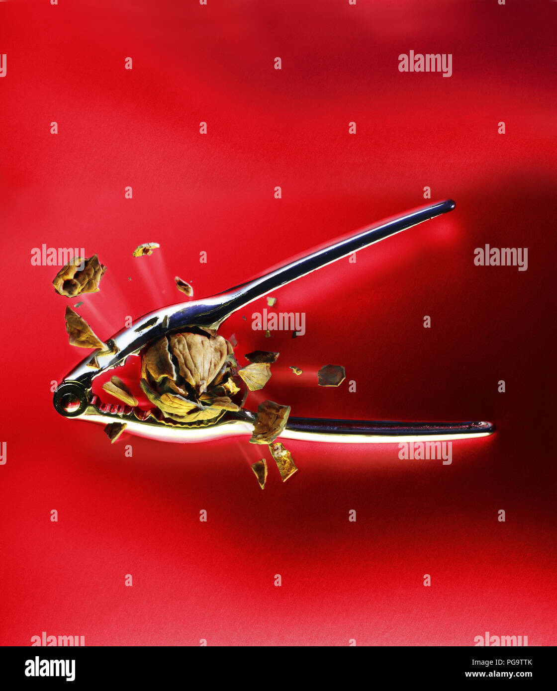 A nutcracker cracking a nut with flying shells Stock Photo - Alamy