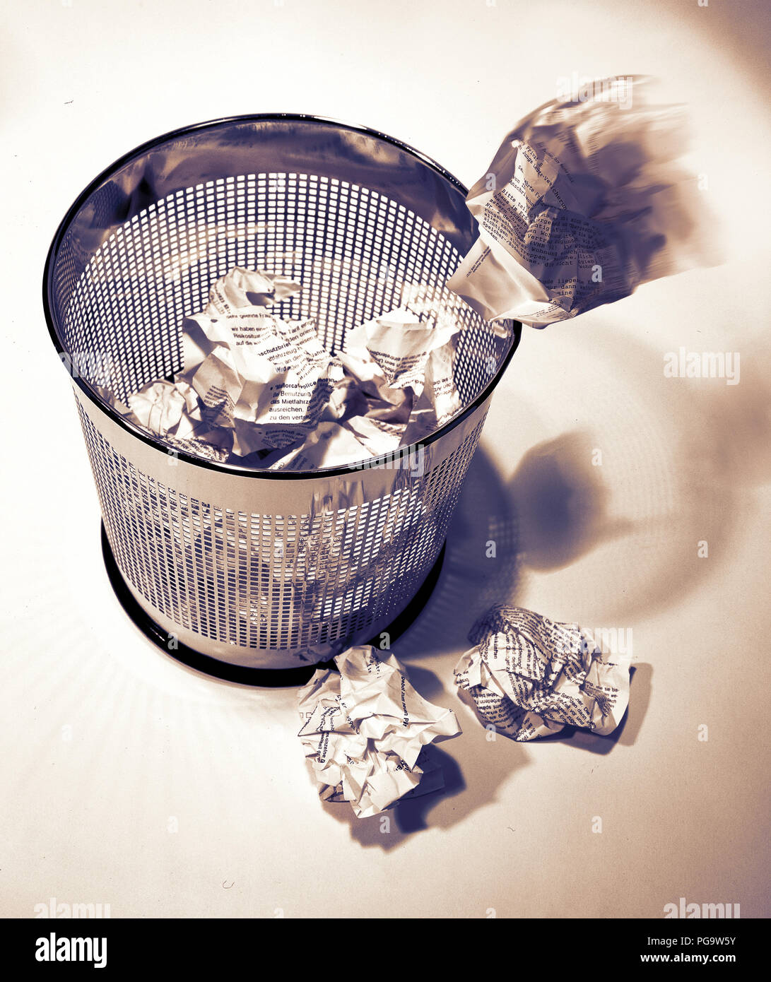 Crumpled paper flying on waste paper bin Stock Photo - Alamy