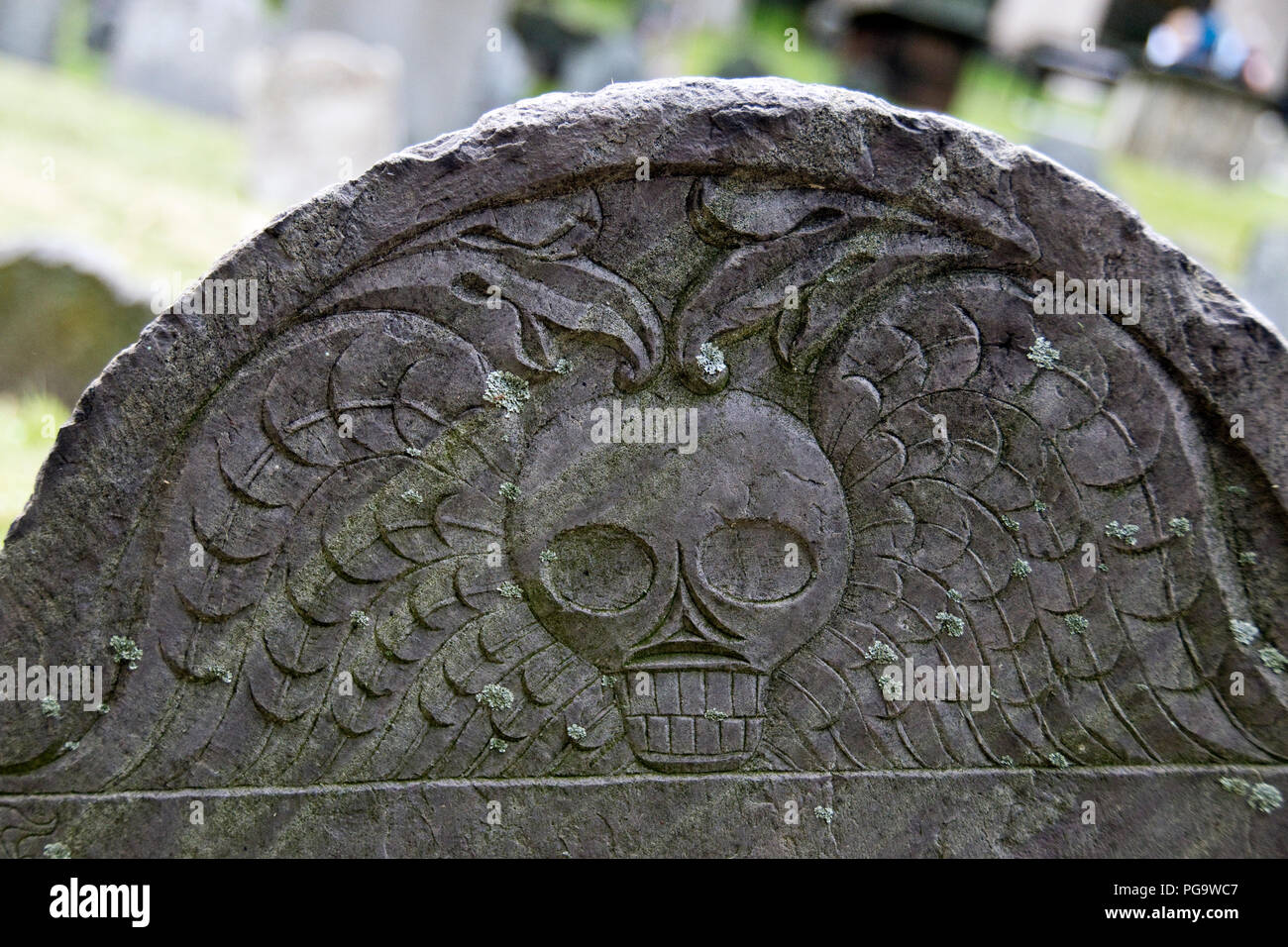 A skull with wings decorates a colonial period grave stone in the ...