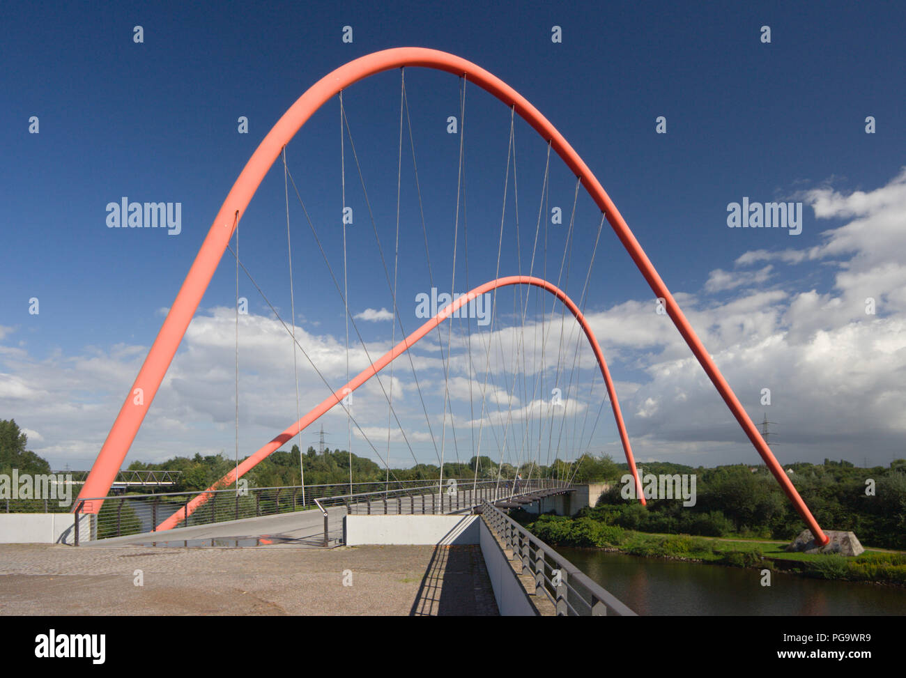 A modern suspension bridge for pedestrians over a canal in ...