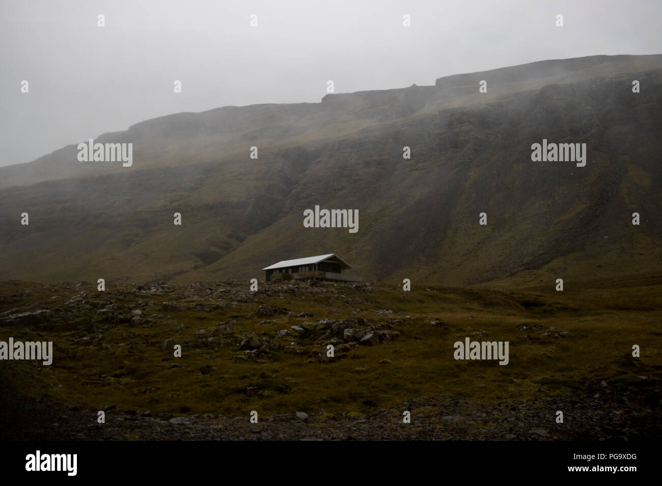Isolated cabin in the mountains during a rain storm in Iceland ...