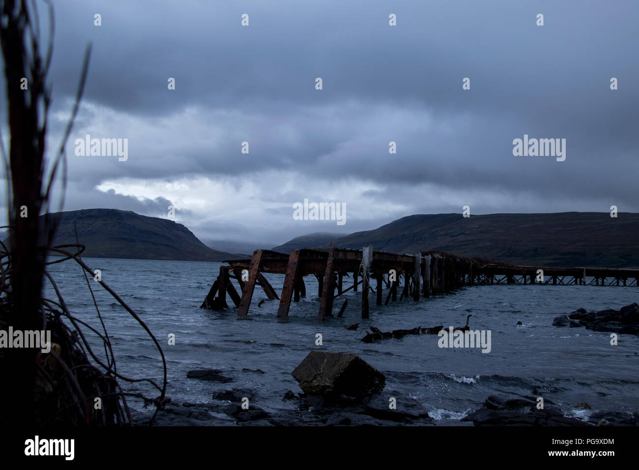 Stormy weather scene with mountains, bridge, and rain clouds. Dramatic ...