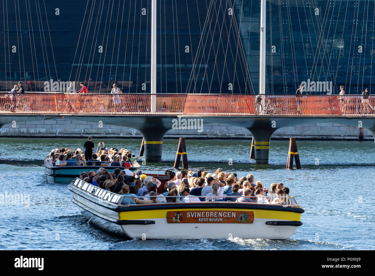 Canal tour boats approaching Cirkelbroen (Circle Bridge) in Copenhagn ...
