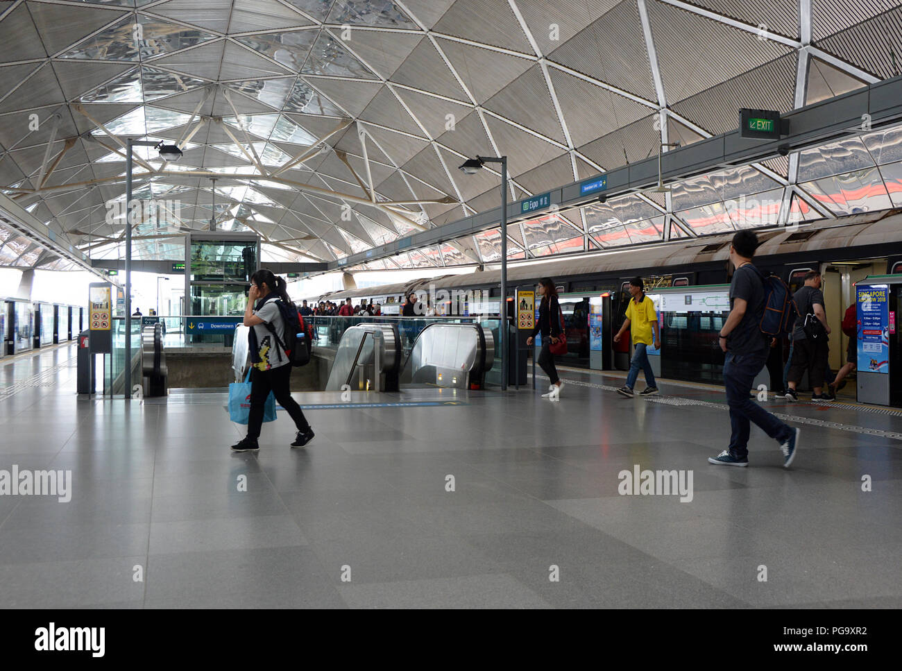Commuters cross the platform at a tube station in Singapore. The ...