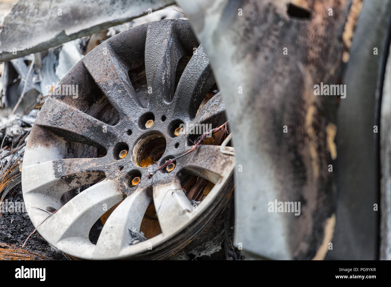 Detail of an alloy wheel from a burnt vehicle Stock Photo - Alamy