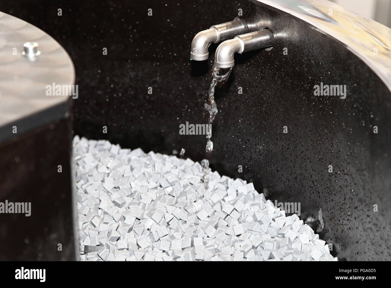 Vibrating polishing machine for finishing metal parts Stock Photo - Alamy
