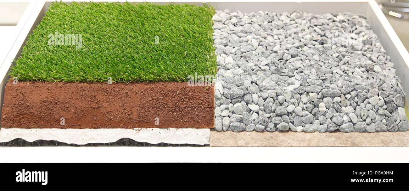 Layers of artificial synthetic grass and pebbles for sports fields ...