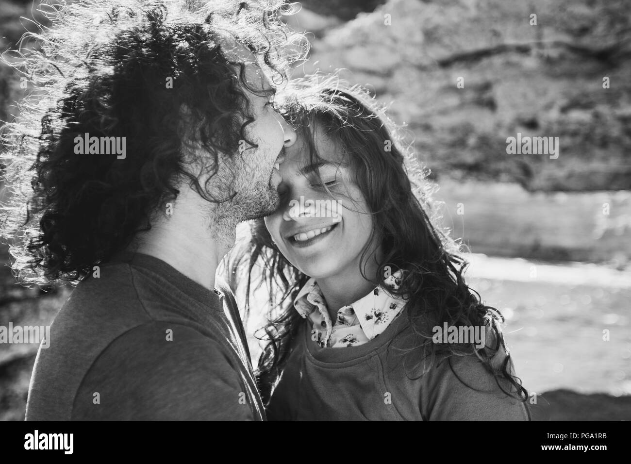 Lovely couple having fun in sunlight. Long curly hair, happiness and ...