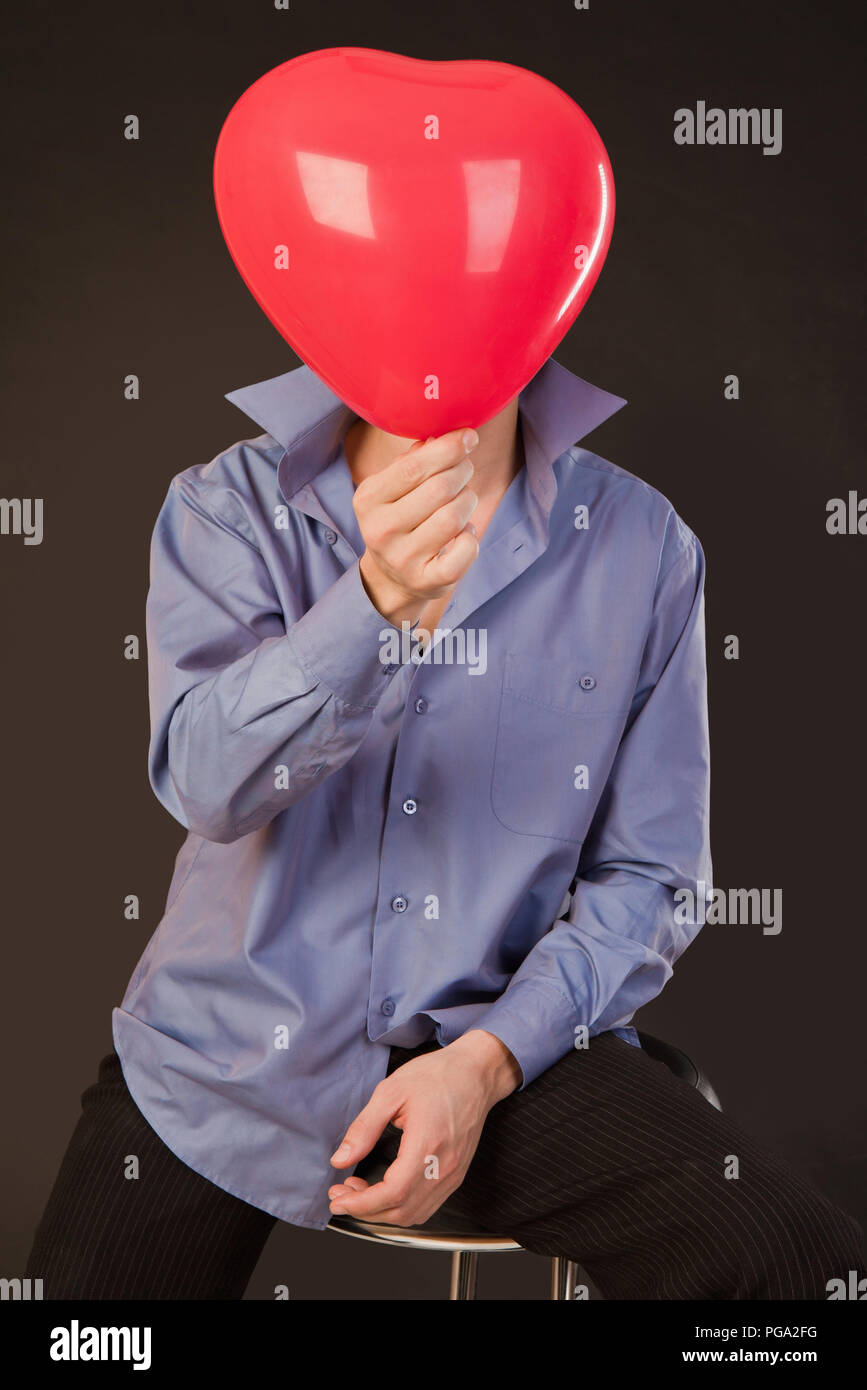 guy holds a balloon in the form of heart Stock Photo - Alamy