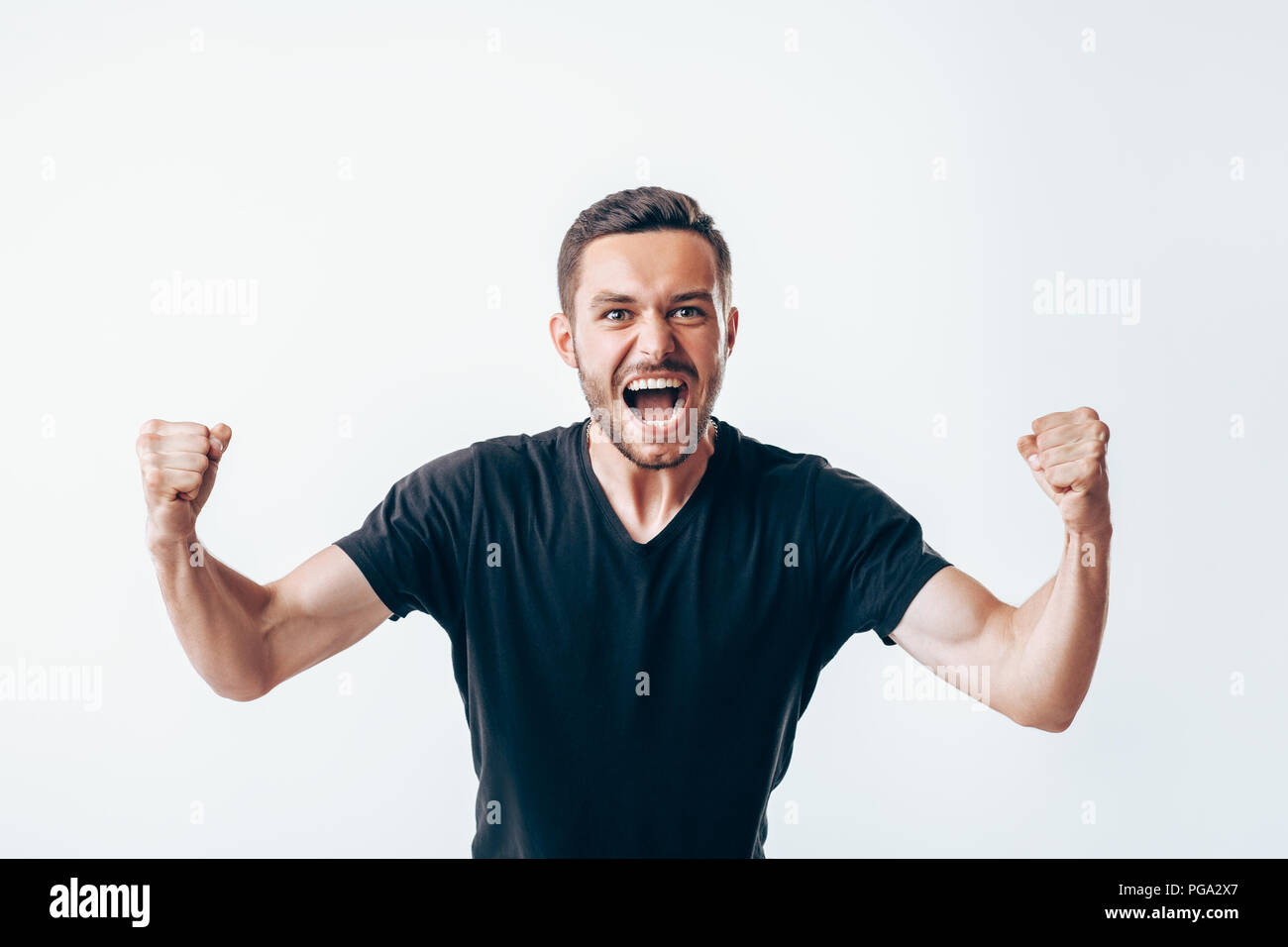Happy winner man with fists up celebrating success Stock Photo - Alamy