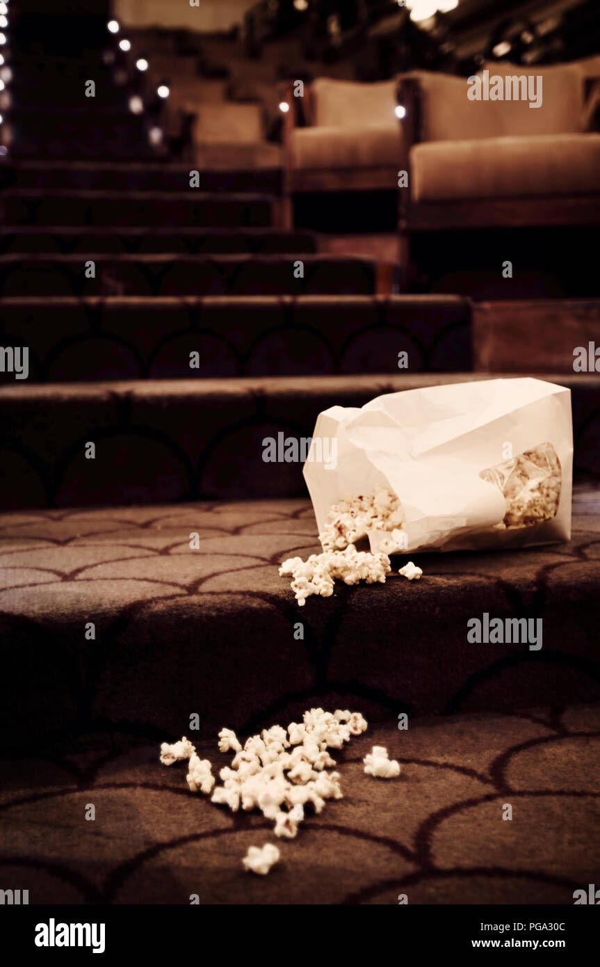 Spilt popcorn on movie cinema floor. Style: "70's look Stock Photo - Alamy