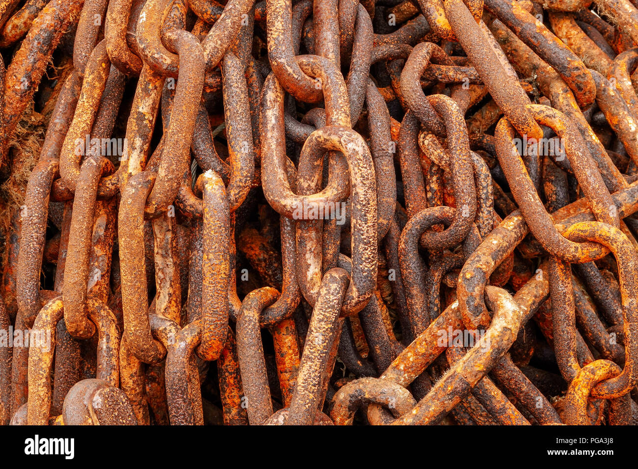 A closeup of a pile of big link old rusty ships anchor chains Stock ...
