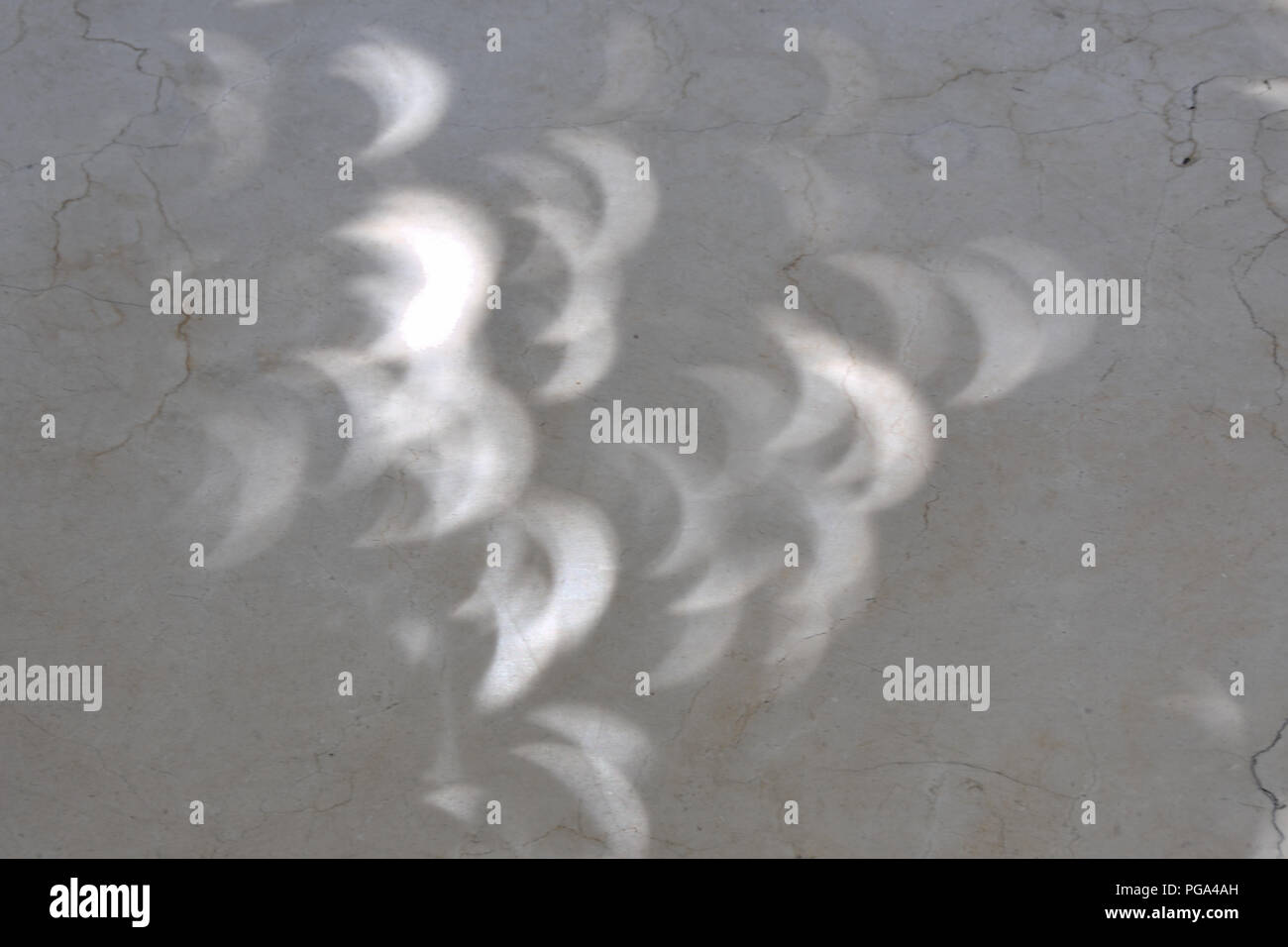 reflection of solar eclipse displayed on marble floor Stock Photo - Alamy